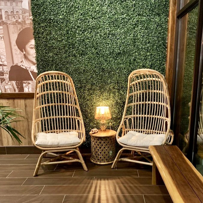 These rattan chairs against a lush green wall aren't just Instagram-worthy &ndash; they're the perfect spot to rest while contemplating a second helping.