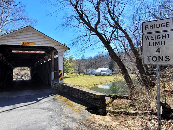 The weight limit sign stands guard, ensuring this historic treasure remains standing for future generations of curious wanderers.