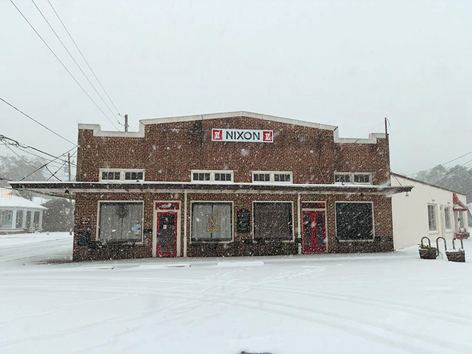 Snow transforms this brick storefront into a winter wonderland, a rare sight in coastal Alabama that turns ordinary errands into magical adventures.