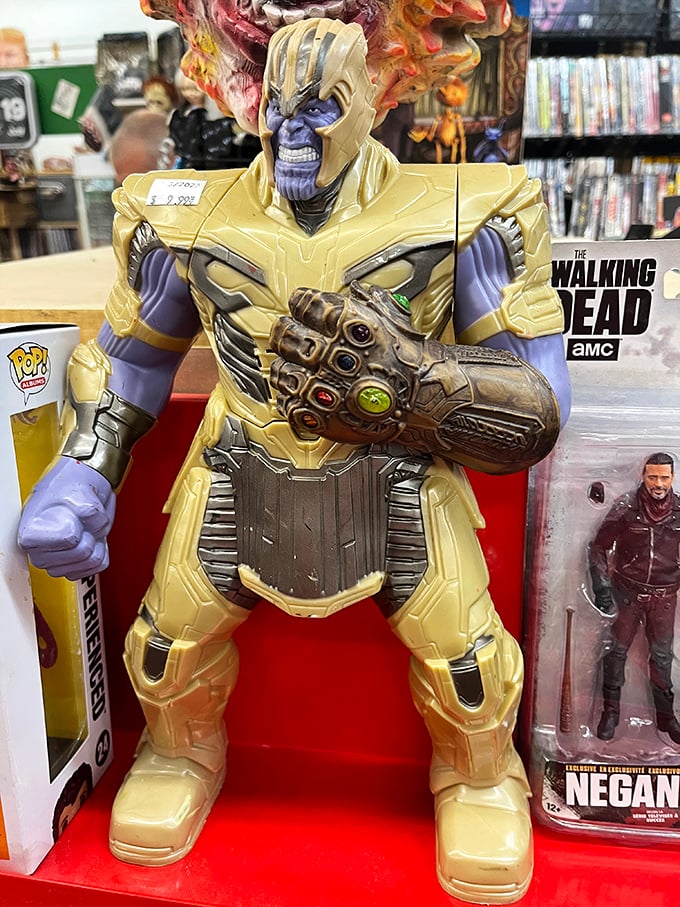 Thanos stands guard over Walking Dead memorabilia, proving that even villains need weekend side hustles at the flea market.