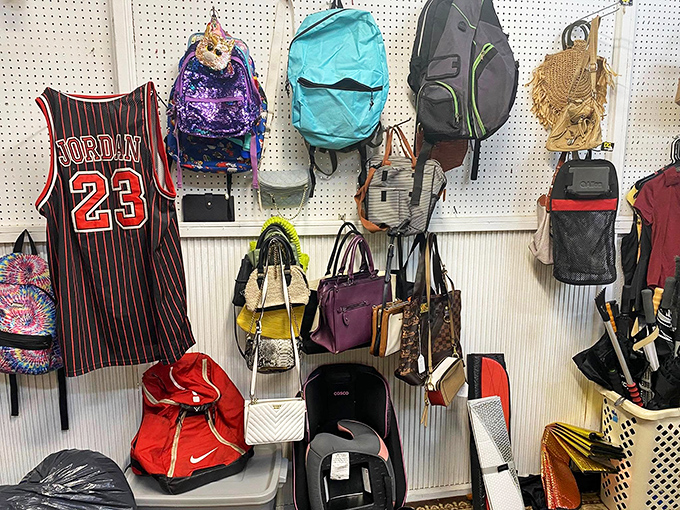 A Michael Jordan jersey presides over a pegboard kingdom of backpacks and purses, where designer labels mingle with practical everyday carriers.