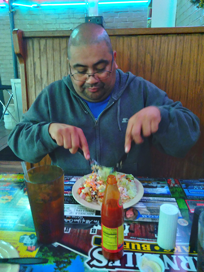 This gentleman knows the universal truth of buffet dining – proper plate architecture is the difference between amateur hour and championship eating.