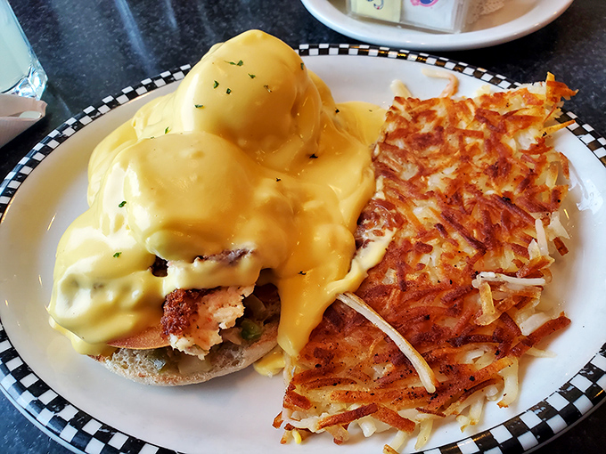 Hollandaise heaven on earth. This Eggs Benedict with golden hash browns could make even the most dedicated night owl embrace breakfast.