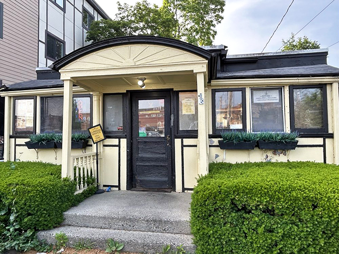 The entrance to Casey's welcomes visitors with tidy shrubs and flower boxes, a humble facade that belies the culinary institution waiting inside.