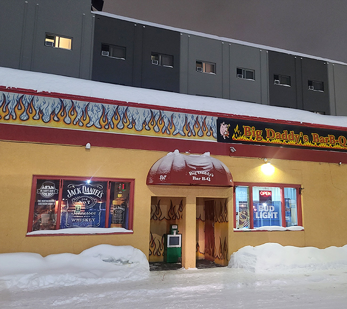 Even buried in snow, Big Daddy's flame-painted doors beckon like a mirage of warmth and smoky delights in the Alaskan winter.
