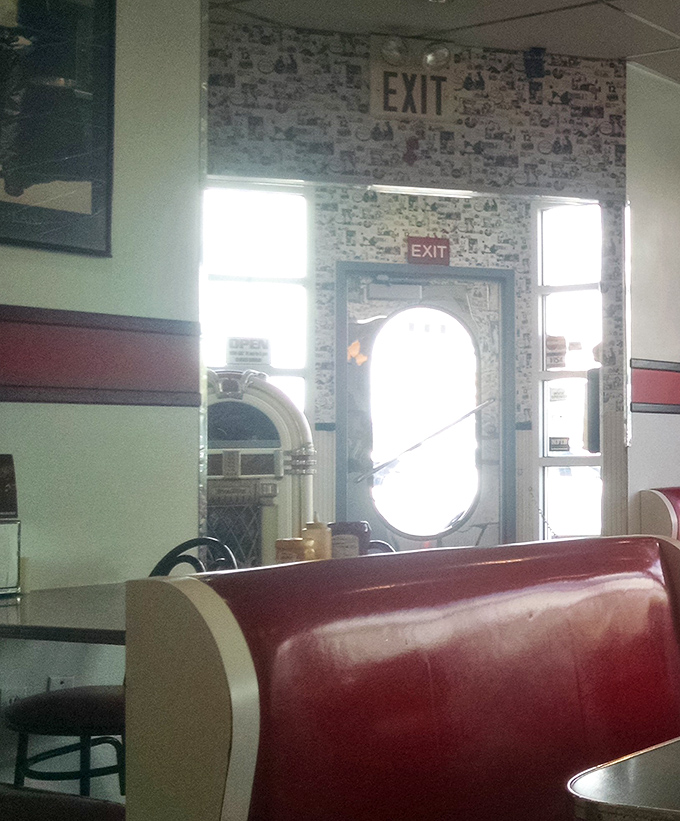 The exit view reveals wallpaper collaged with memories, a visual history book of American diner culture.