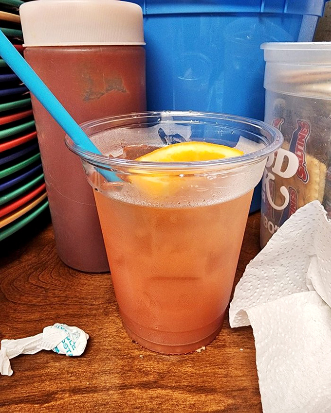 A refreshing amber elixir with a blue straw standing at attention. In the Alabama heat, this isn't just a drink—it's survival equipment.