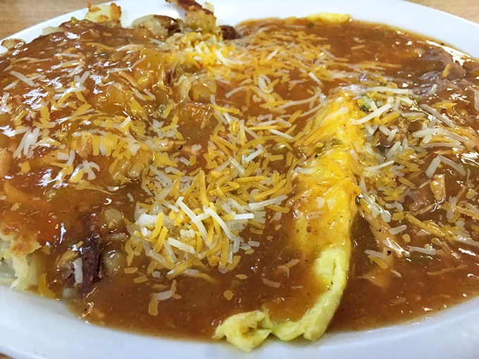 Huevos rancheros swimming in chili and cheese—where breakfast crosses borders and nobody needs a passport.
