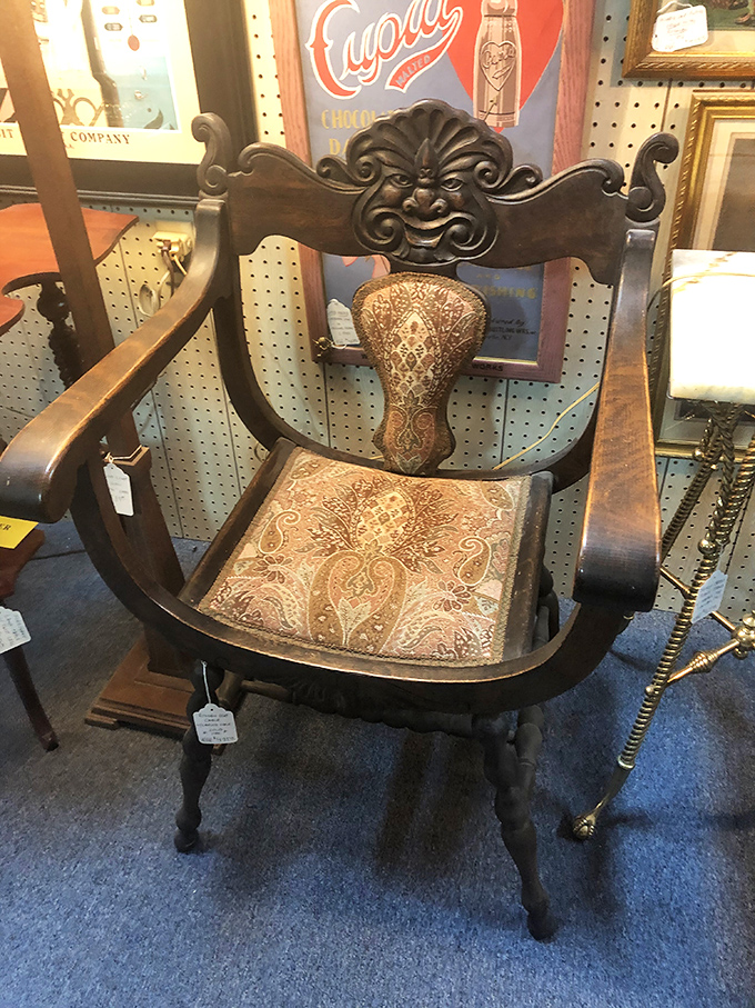 That face carved into the chair back has seen things! This ornate armchair wasn't just furniture&mdash;it was a throne for the living room kingdom.