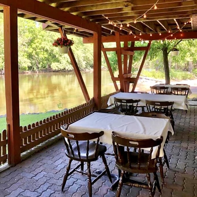 Outdoor riverside tables where summer evenings stretch longer than Minnesota winters. The gentle sound of flowing water makes everything taste just a little bit better.