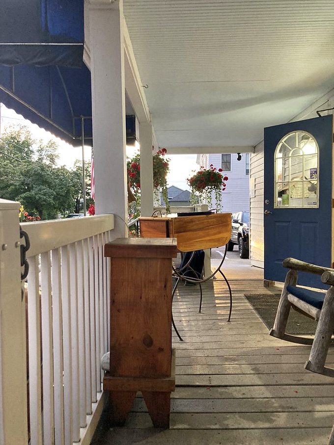 The front porch offers a quiet moment before dinner – rocking chairs and wooden tables that whisper "slow down, you're on island time now."