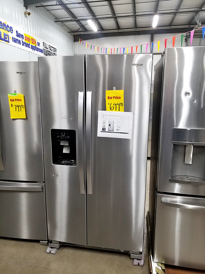 Stainless steel refrigerators stand at attention, their yellow price tags announcing the kind of savings that make upgrading from that old fridge suddenly possible.