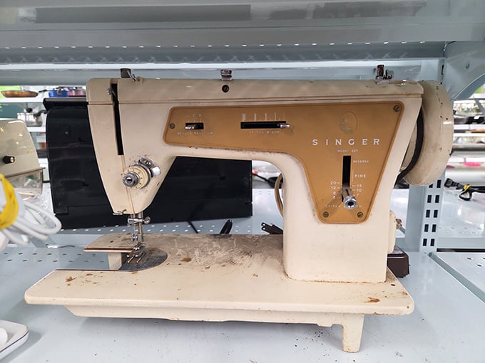 A vintage Singer sewing machine waits patiently for creative hands—this mechanical workhorse has mended and created through decades of fashion evolution.