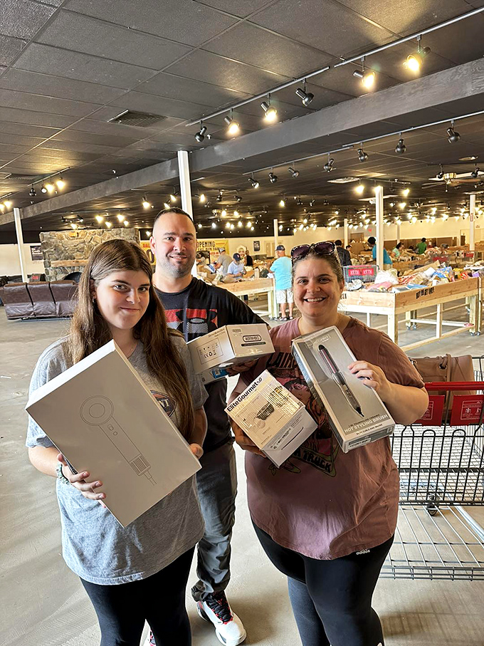 Happy hunters showing off their electronic treasures. Those smiles say it all: mission accomplished, money saved.
