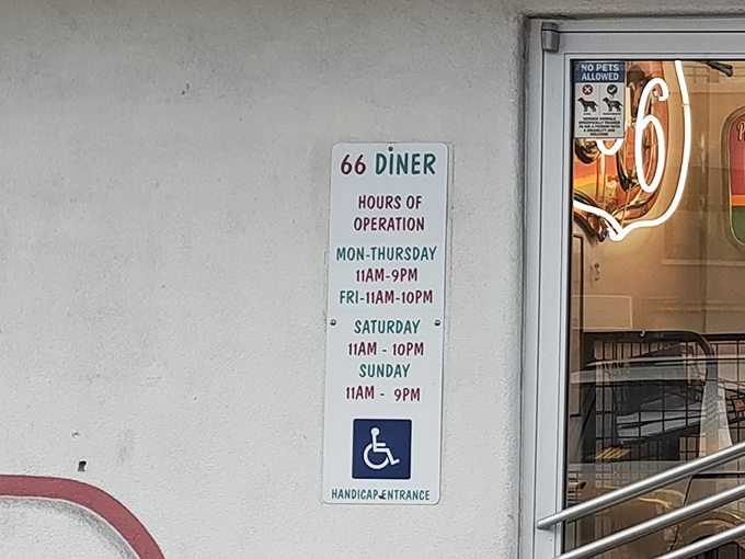 Hours posted like a promise&mdash;seven days a week of retro dining pleasure. The accessibility symbol: because great shakes are for everyone.