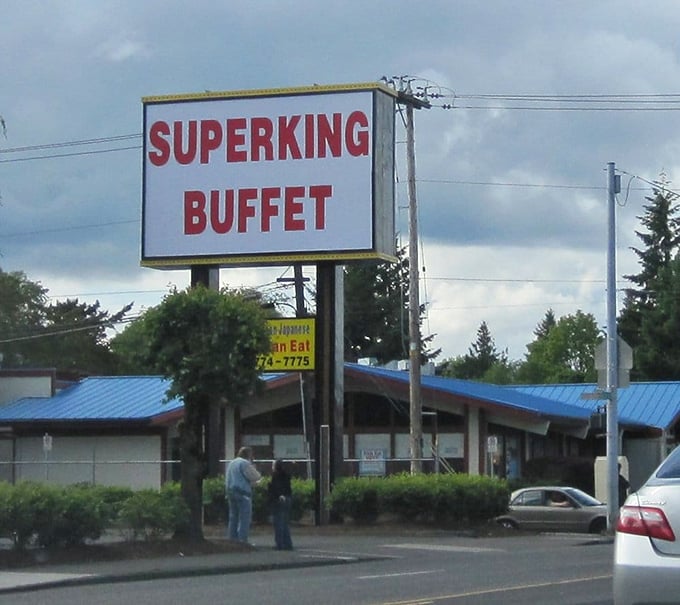 The roadside sign stands tall against the Portland sky, a beacon of abundance calling to hungry travelers like a siren song.