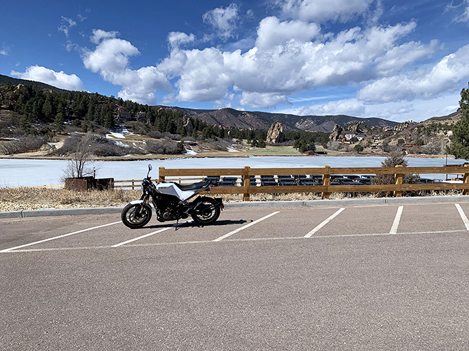 This motorcycle-and-mountain vista embodies Colorado freedom &ndash; the promise that adventure waits just beyond the next bend in the road.