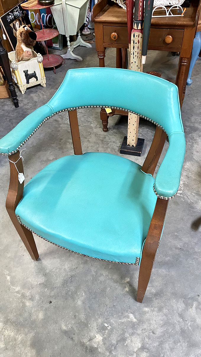 That turquoise mid-century chair isn't just furniture—it's a time machine to the Mad Men era, minus the cigarette smoke.