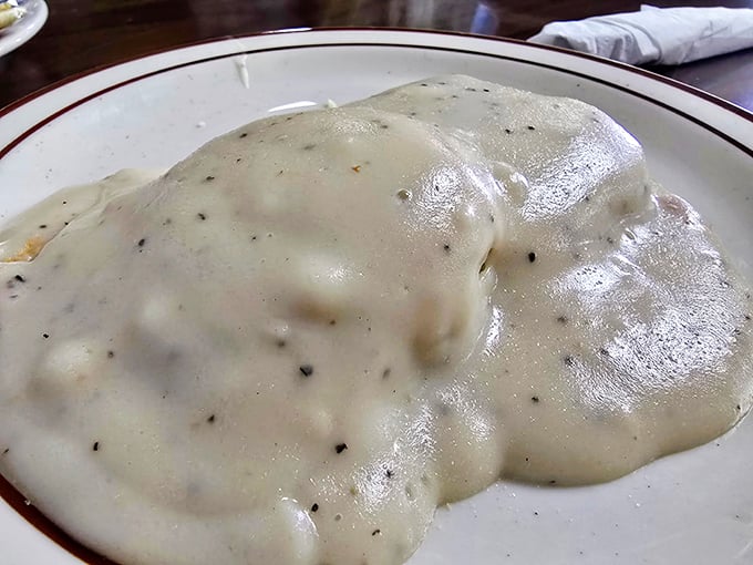Biscuits and gravy that doesn't just sit on the plate&mdash;it beckons with peppery, creamy goodness that makes you understand why some foods become legends.