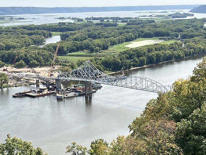The mighty Mississippi flows beneath the historic Black Hawk Bridge, connecting not just two states but linking present travelers to America's storied past.