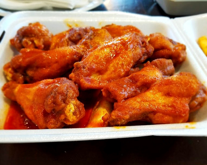 Wings that make you question why anyone would complicate such a perfect food. That vibrant sauce clings to each piece like it's afraid of abandonment.