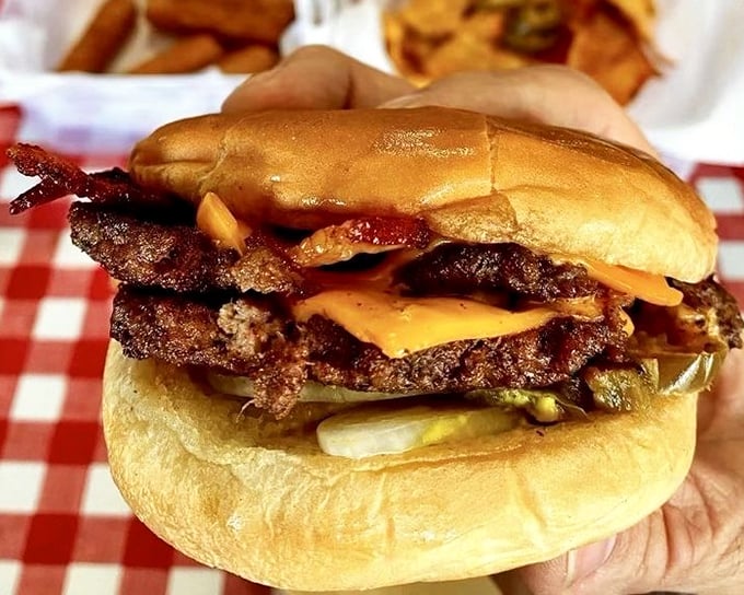This isn't just a burger in someone's hands&mdash;it's a Mississippi tradition being passed down, one perfect patty at a time.