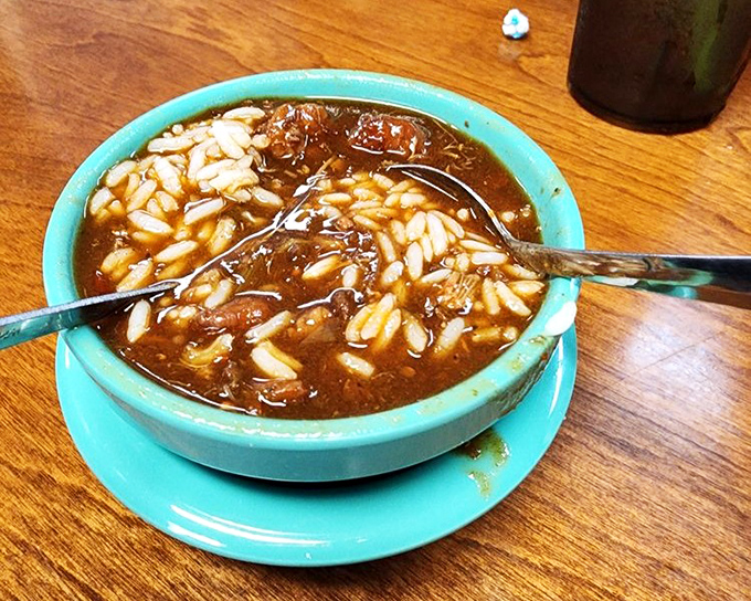 Gumbo that tells the story of the Gulf in every spoonful. Rice and rich broth mingling like old friends at a reunion—comfort in a turquoise bowl.