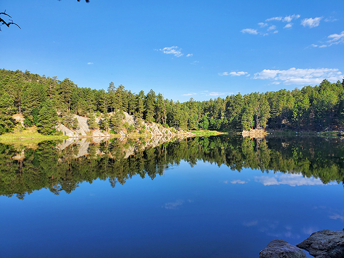 Horse Thief Lake's mirror-like surface perfectly reflects the surrounding pines – nature showing off its photoshop skills without any digital assistance.