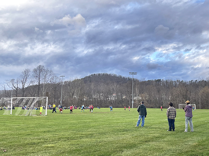 Weekend warriors and proud parents dot the sidelines. Local sports fields connect generations through the timeless ritual of cheering for the home team.