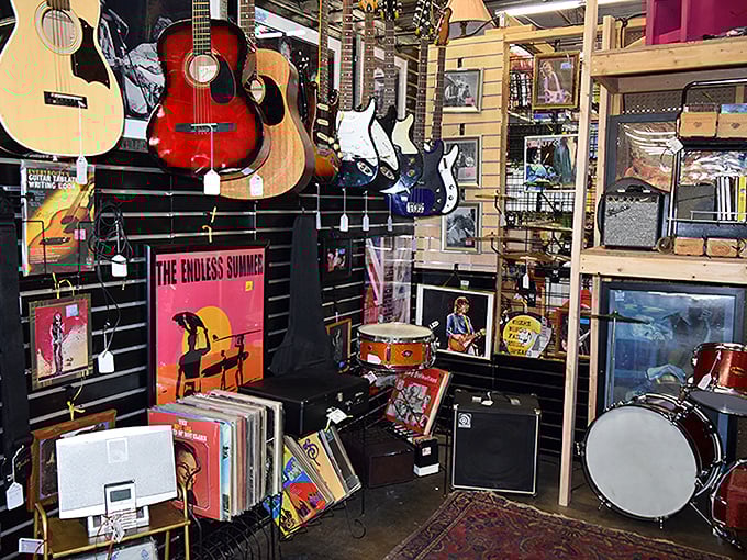 The music corner where instruments wait for their second act. That red guitar has probably played everything from "Smoke on the Water" to "Wonderwall."