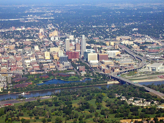 From above, Omaha reveals its perfect balance of urban development and green spaces. The Missouri River curves around the city like nature's own hug.