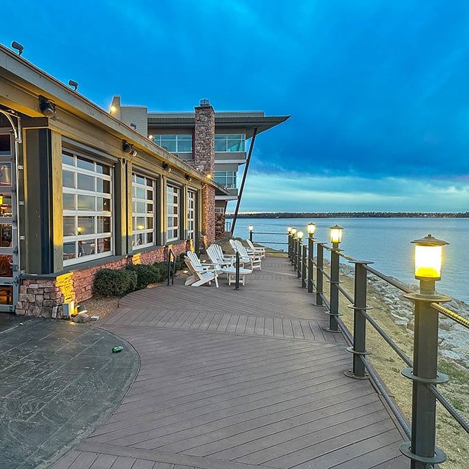 Adirondack chairs line the waterfront deck, inviting diners to linger as the lake reflects the day's final light.