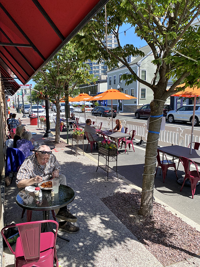 Sidewalk dining under orange umbrellas—where Federal Hill's vibrant street life becomes the perfect appetizer to your meal.