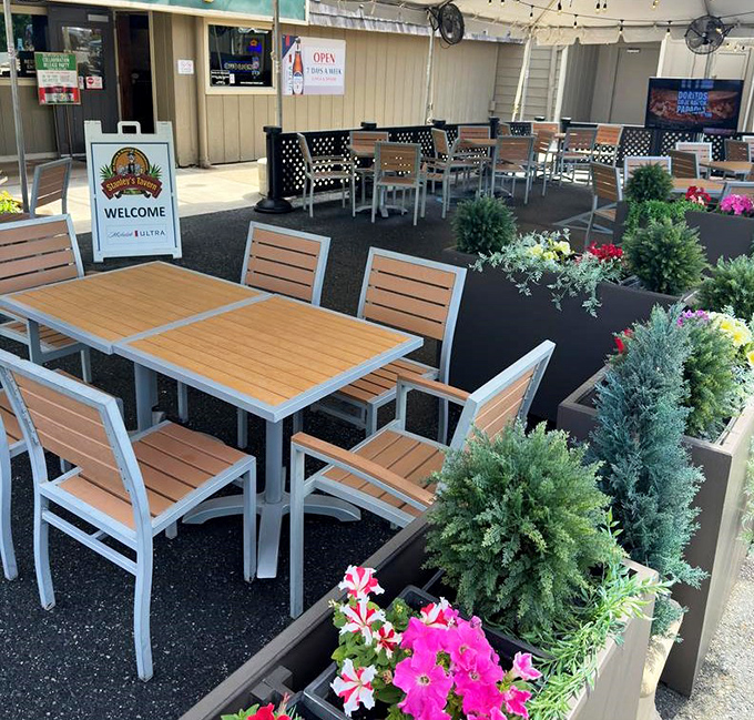 The outdoor seating area, surrounded by colorful flowers and greenery, offers a peaceful retreat for enjoying your meal in Delaware's pleasant weather.