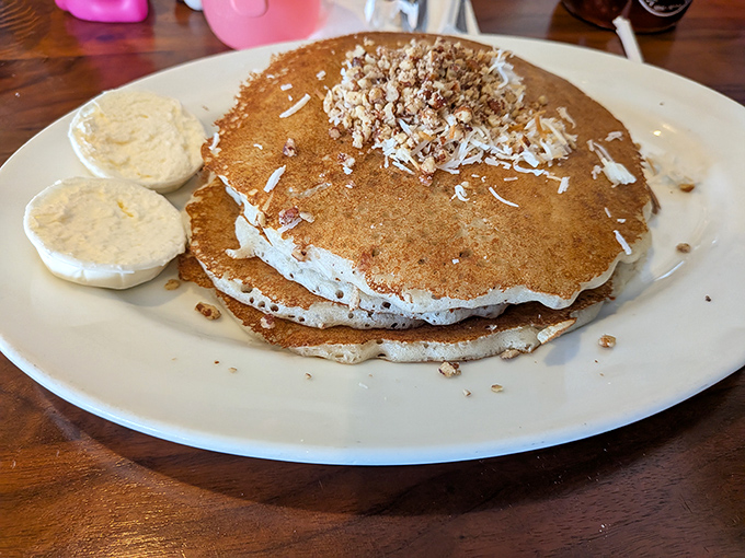 This isn't just a pancake—it's a golden-brown canvas of breakfast artistry. The coconut and crumble toppings are the supporting actors in this delicious drama.