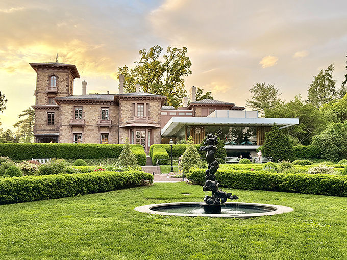 Garden elegance meets architectural history at Prospect House, where a fountain's gentle music accompanies nature's own spectacular sunset show.