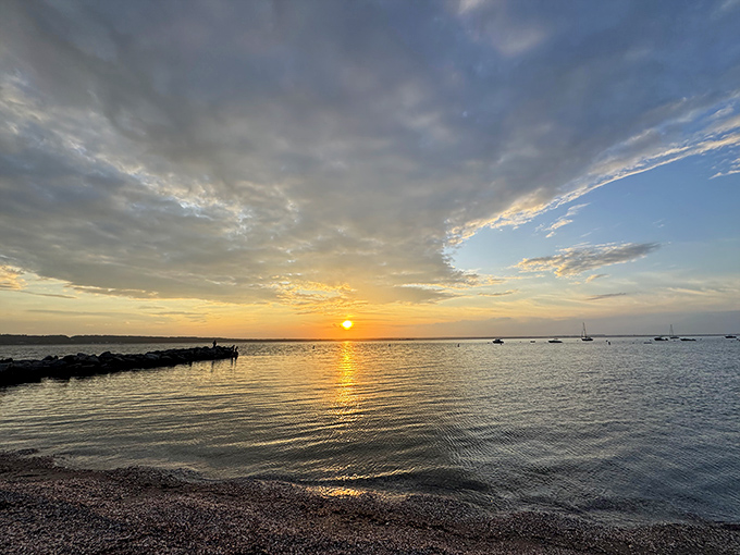 Golden hour perfection at Shore's Beach, where the setting sun transforms Narragansett Bay into a shimmering pathway of light.