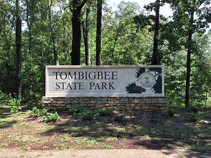 The welcoming stone entrance sign stands as a promise &ndash; beyond these trees lies your next favorite Mississippi getaway.