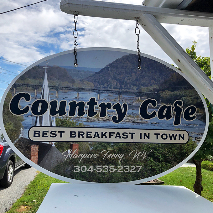 A sign that doesn't just mark a location but makes a bold claim: "Best Breakfast in Town" with mountains and river as witnesses to back it up.