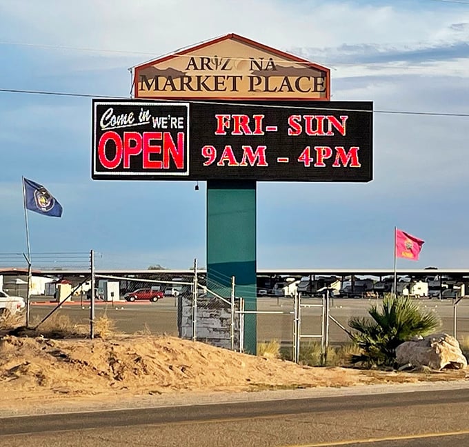 The market's welcoming sign stands like a desert lighthouse, guiding bargain-seekers to this weekend retail oasis from Friday through Sunday.