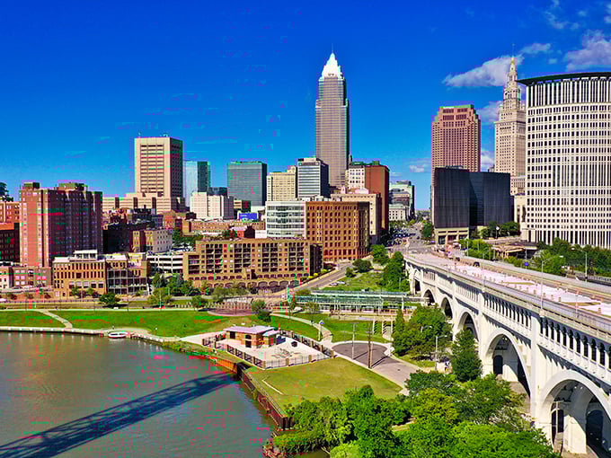 The aerial view showcases Cleveland's brilliant riverfront development, where the once-burning Cuyahoga now anchors a vibrant urban playground.
