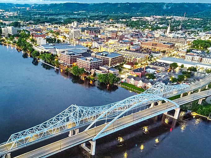 La Crosse's downtown lights twinkle alongside the Mississippi at dusk, creating a postcard-perfect scene that makes you wonder why you didn't move here sooner.