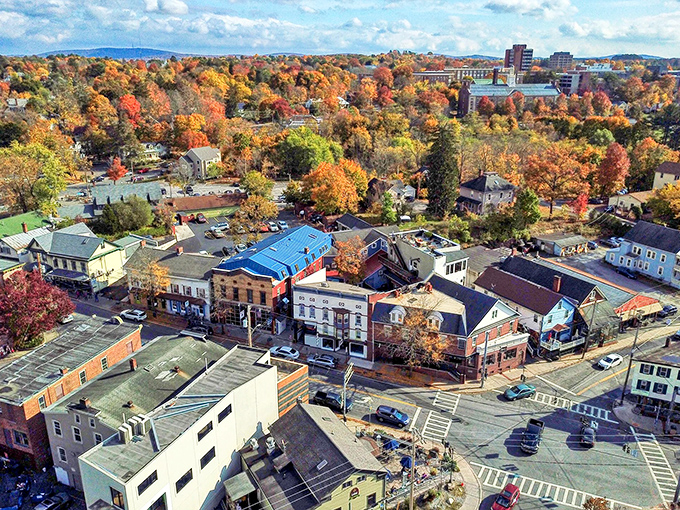 Autumn transforms New Paltz into a painter's palette of reds and golds, revealing the town's perfect balance of nature and civilization from above.