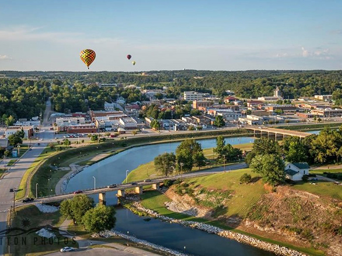 Hot air balloons drift over Harrison's picturesque landscape, offering a breathtaking perspective on this affordable retirement haven nestled in the Ozarks.