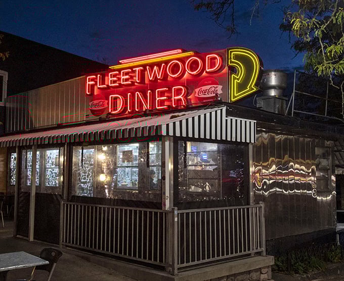 The neon glow of Fleetwood at night beckons like a lighthouse for the hungry, promising safe harbor for midnight cravings and early risers alike.