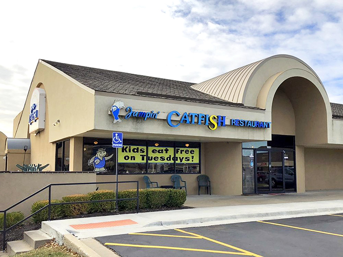 The curved entrance welcomes seafood pilgrims with a promise. That "Kids Eat Free" sign hints at the family-friendly values inside this Kansas institution.