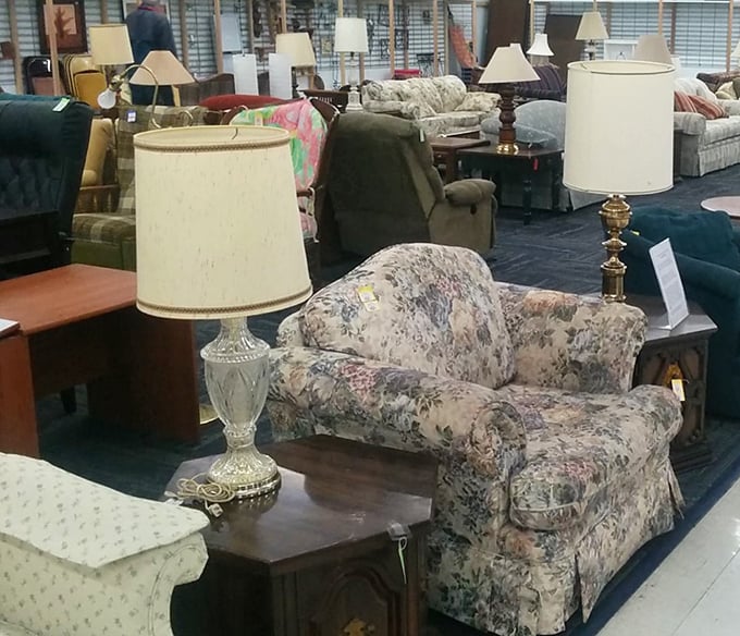 Lamp shades and floral upholstery create a still life of suburban nostalgia. Grandma's chair style is making a comeback&mdash;everything old becomes new again.