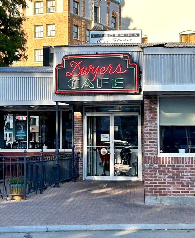 The neon promise of Dwyer's Cafe glows against the Lafayette sky, a siren call to those seeking authentic local flavor.