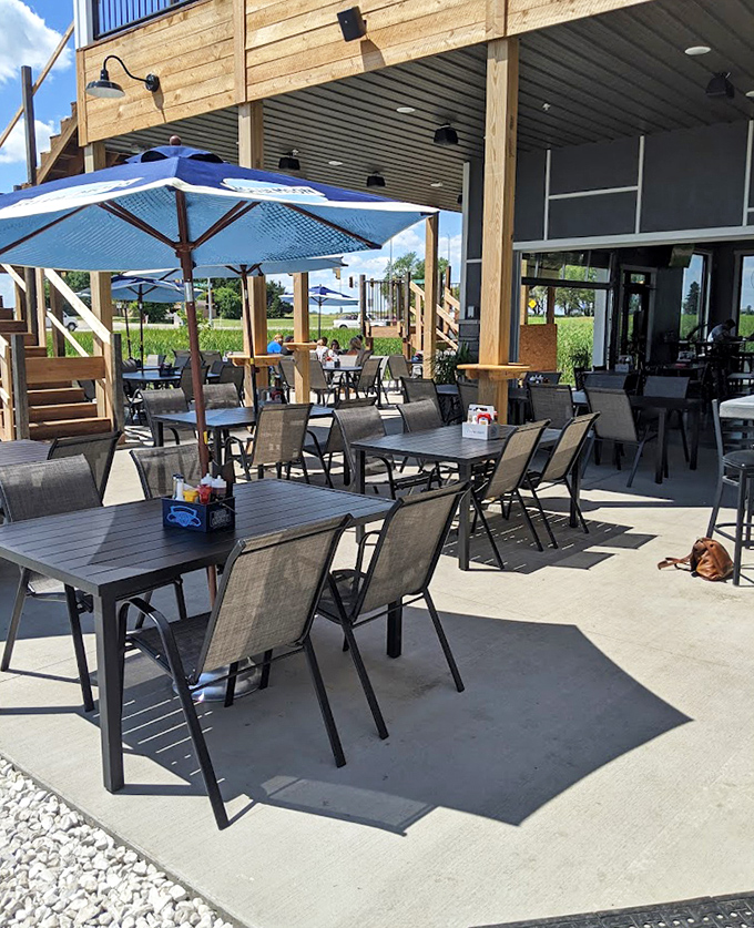 Squealer's outdoor seating area: where summer evenings, cold drinks, and barbecue come together in perfect harmony under big prairie skies.