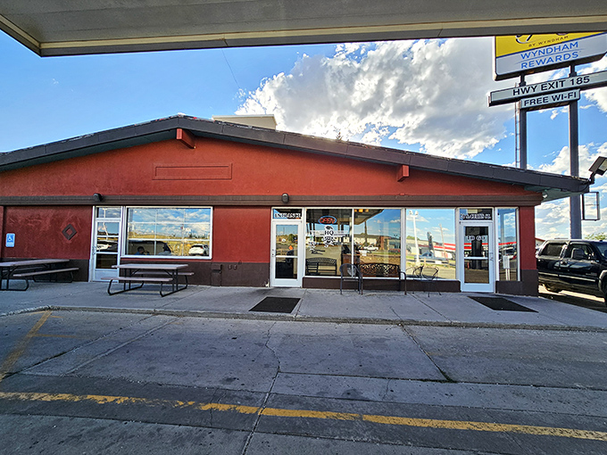 The exterior view showcases Wyoming's dramatic skies above this humble barbecue haven. Big flavors often come from small, unassuming buildings.